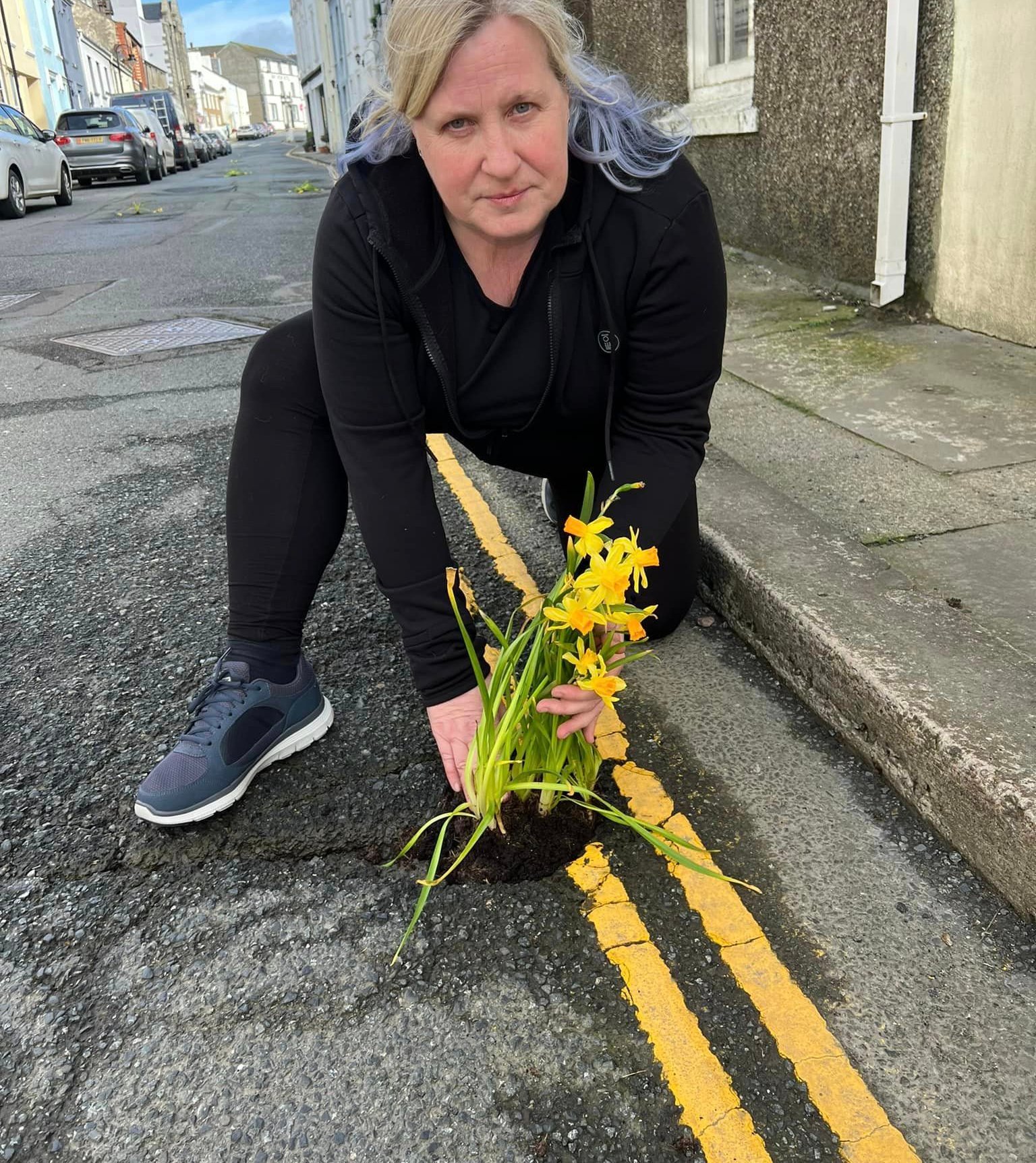 Fed-up Isle of Man politician plants flowers in potholes in protest at ...