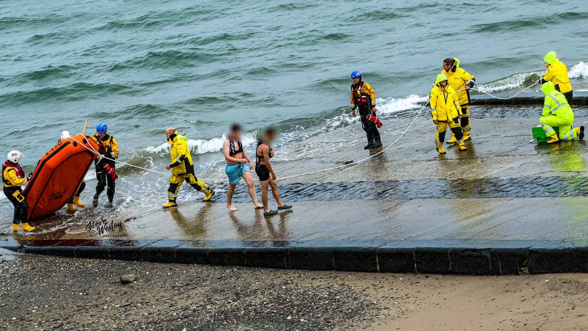 Pictures show dramatic rescue of two stranded in raft off the Isle of ...